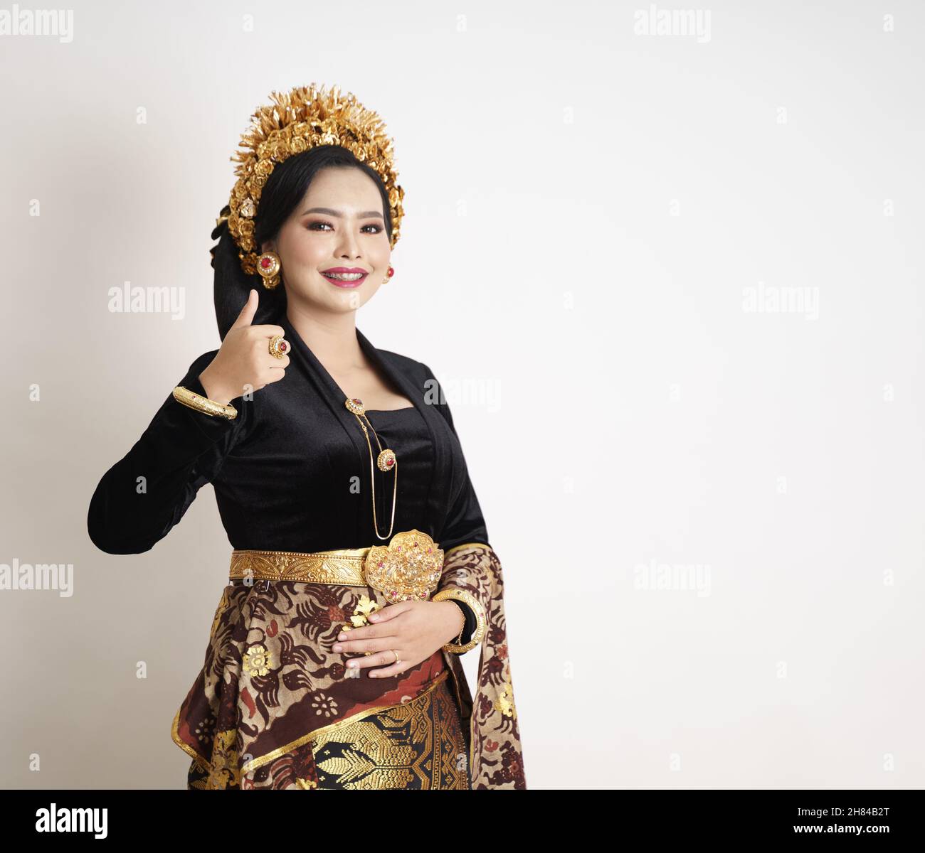 Smiling balinese woman wearing traditional clothes with thumbs up Stock ...