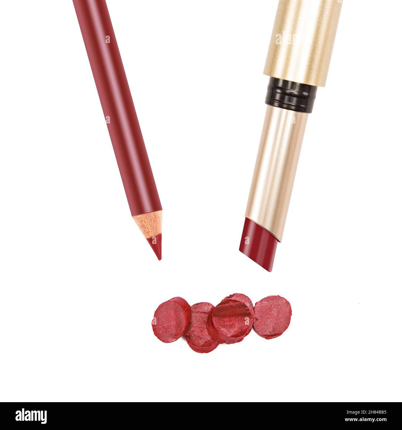 Closeup of dark red lip liner and lipstick with sliced lipstick on ...