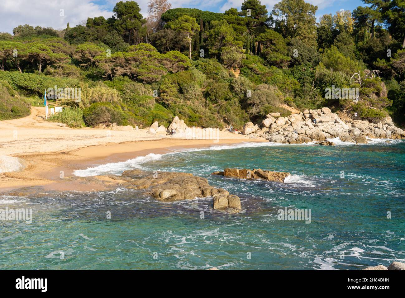 beautiful seascape with small waves around the rocks, and hills with ...