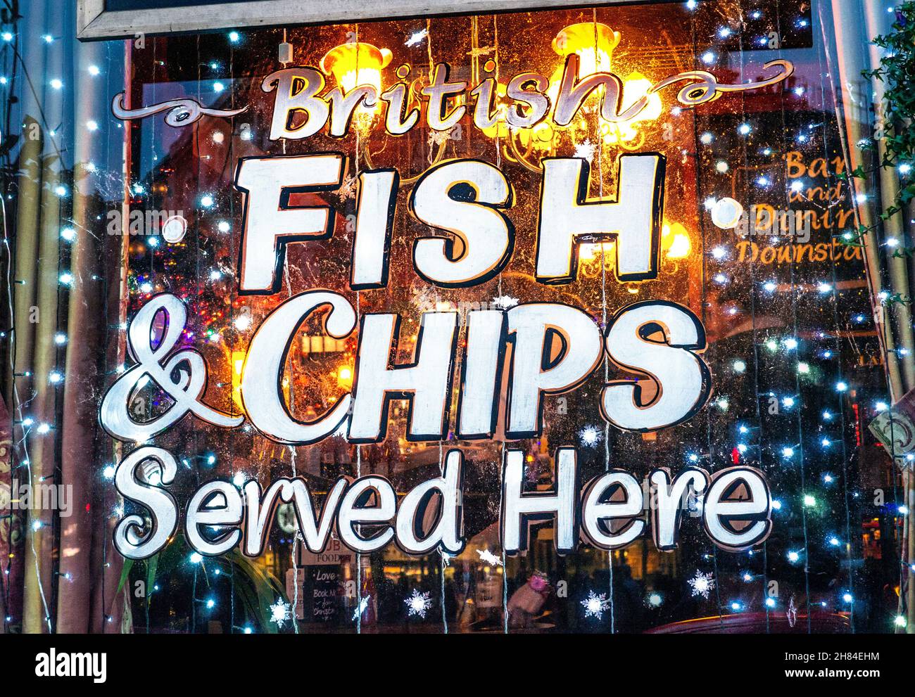Fish and chips sign warm welcoming with frosty snow effect in winter ...