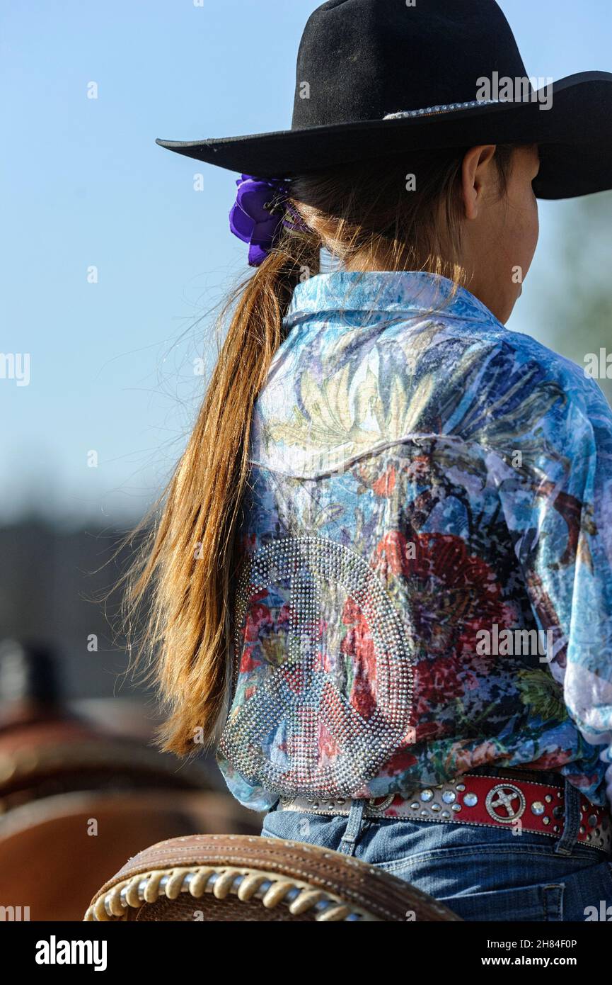 Young female roper with a peace symbol on her shirt at the Tsuu T'ina ...