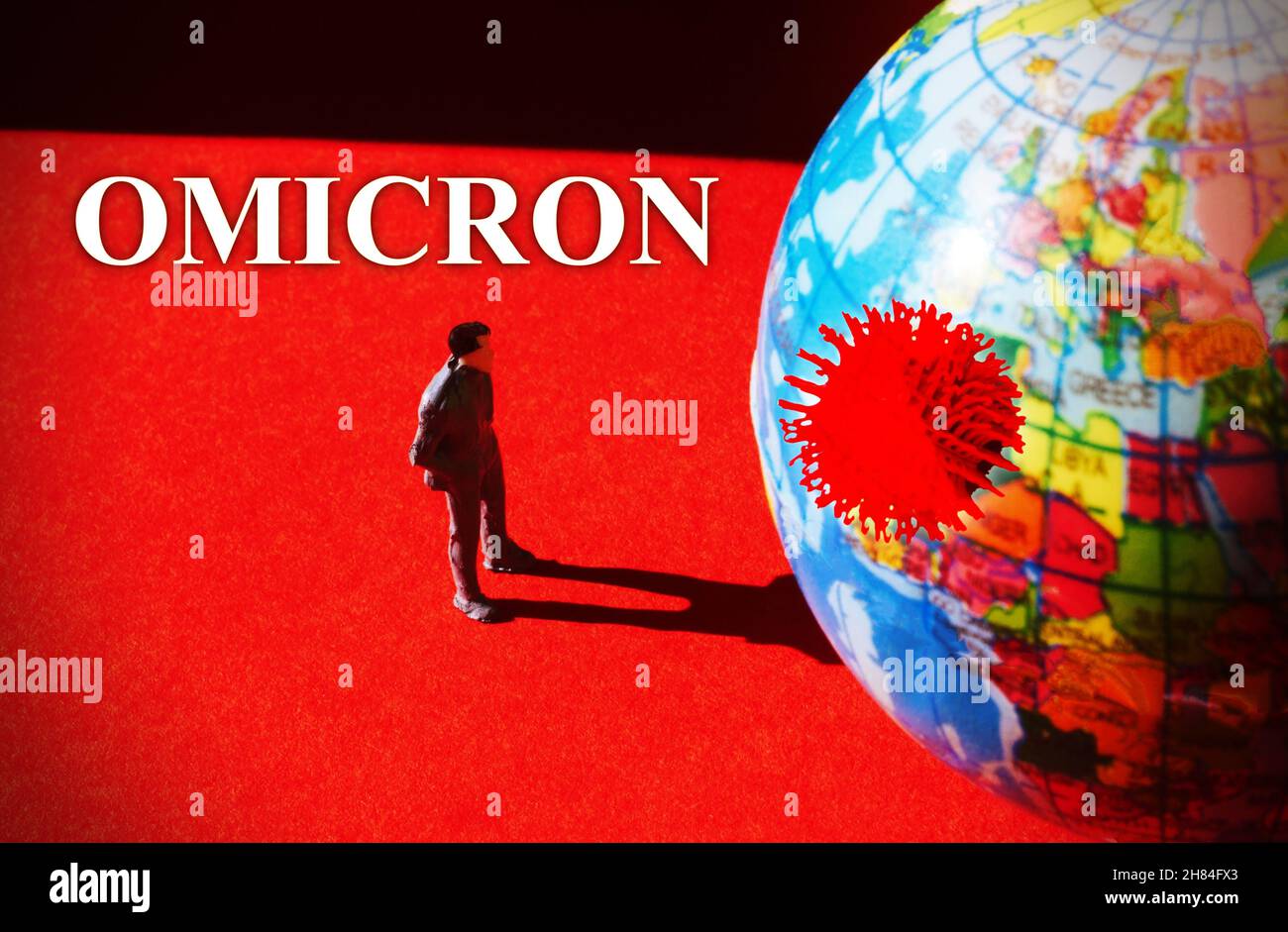 Miniature Man observing the planet earth with the Omicron new variant ...