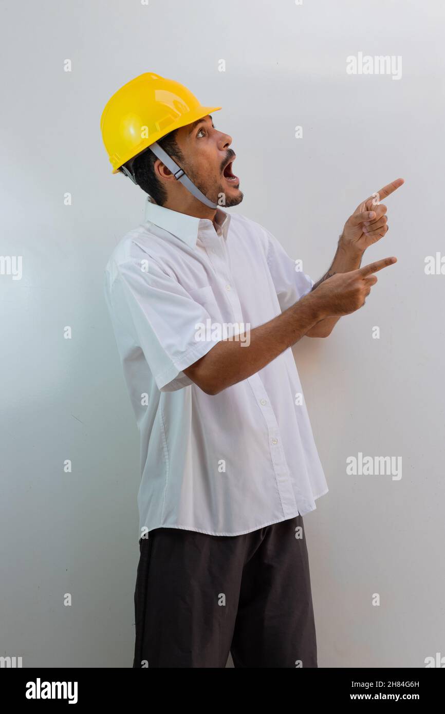 Worker with helmet isolated on white background. Black man surprise ...