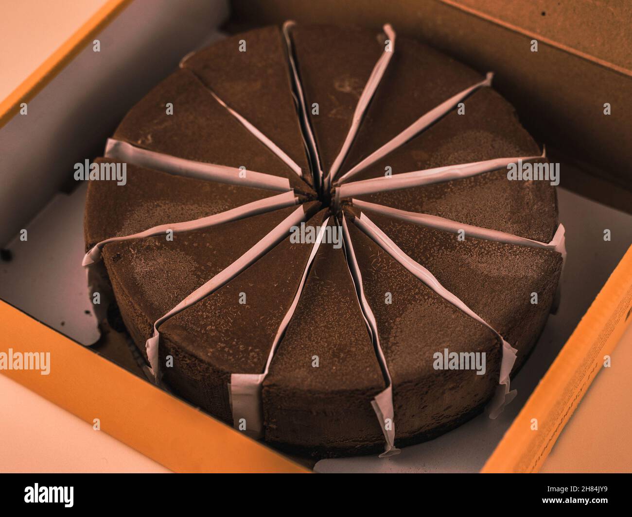 Fresh chocolate cheesecake in opened paper box, close up Stock Photo ...