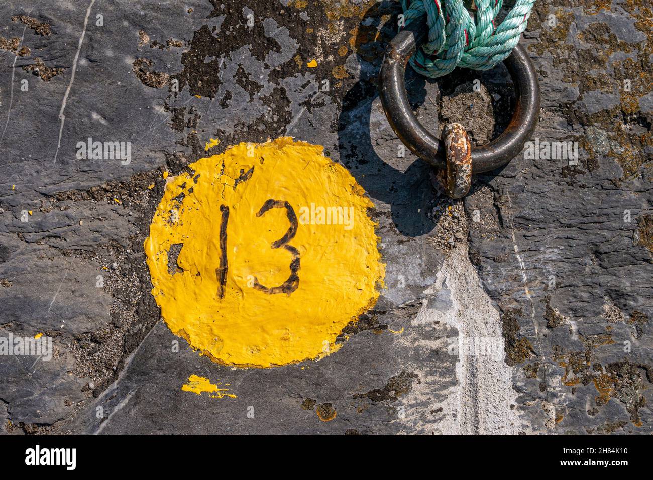 Mooring numbers and a tether on a quayside Stock Photo - Alamy
