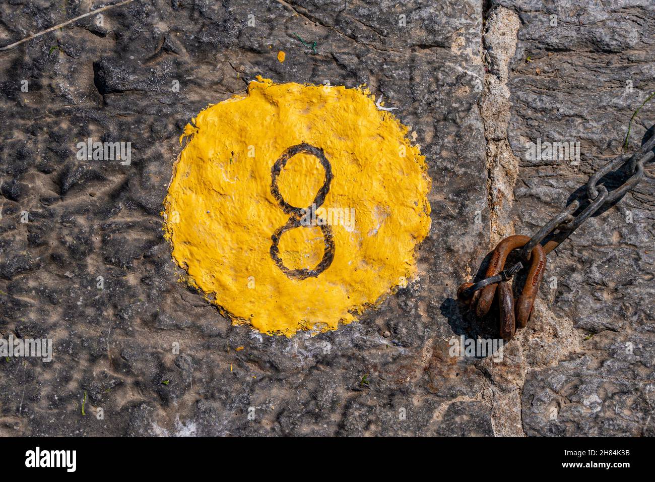 Mooring numbers and a tether on a quayside Stock Photo - Alamy