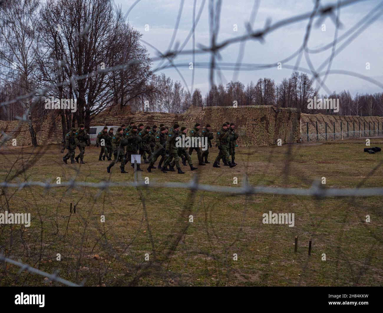 Soldiers of the Russian army walking across a field. View through ...