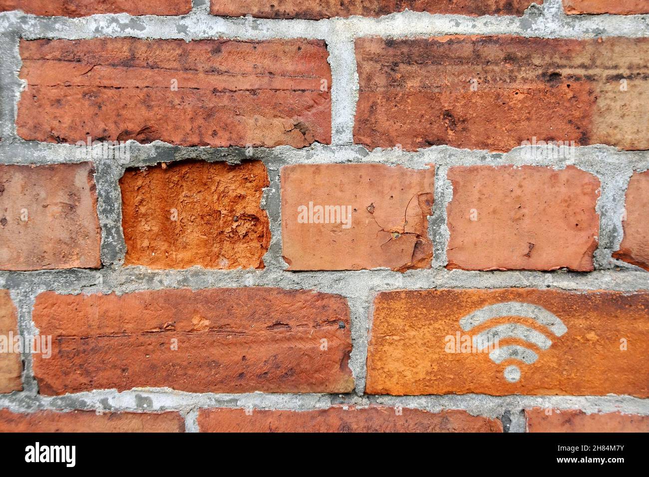 Wi-Fi icon on red brick wall Stock Photo - Alamy