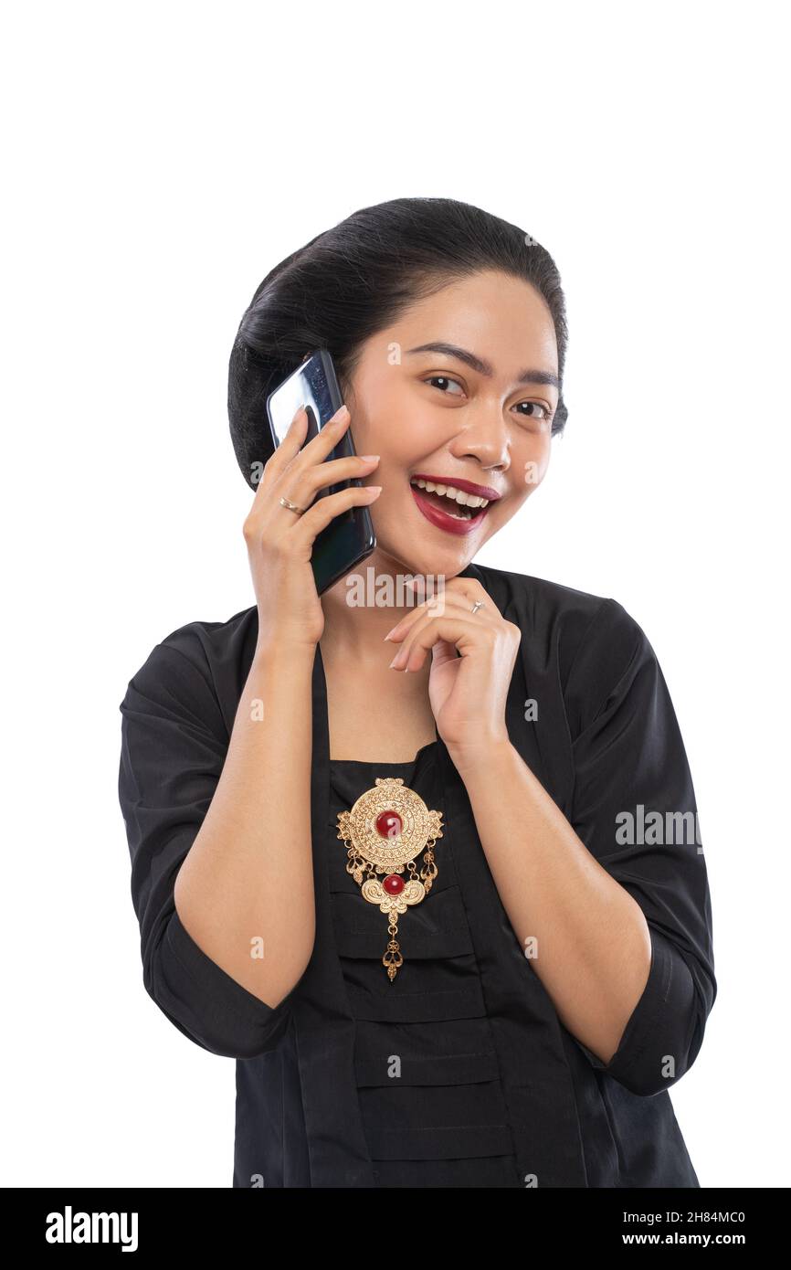 happy asian woman with kebaya calling on phone Stock Photo - Alamy