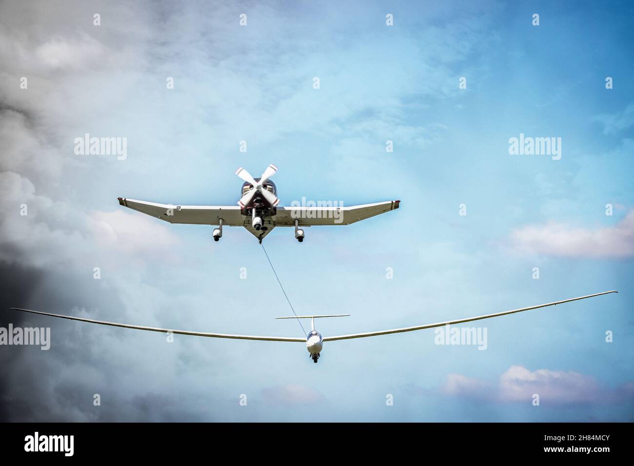 a single engine plane towing a glider to cruise altitude Stock Photo ...