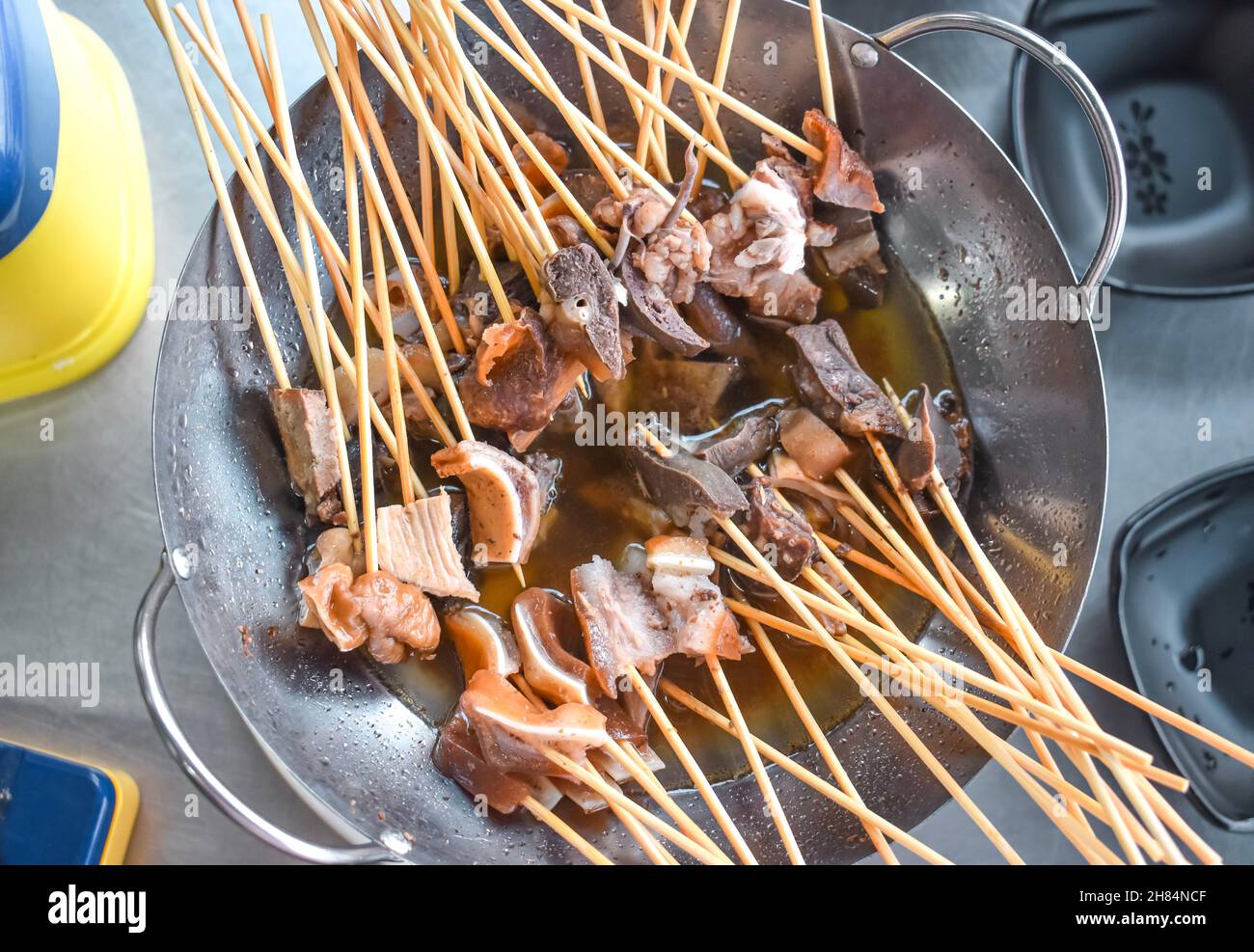 Boiled pork variety meats on bamboo sticks. Famous Myanmar street food ...