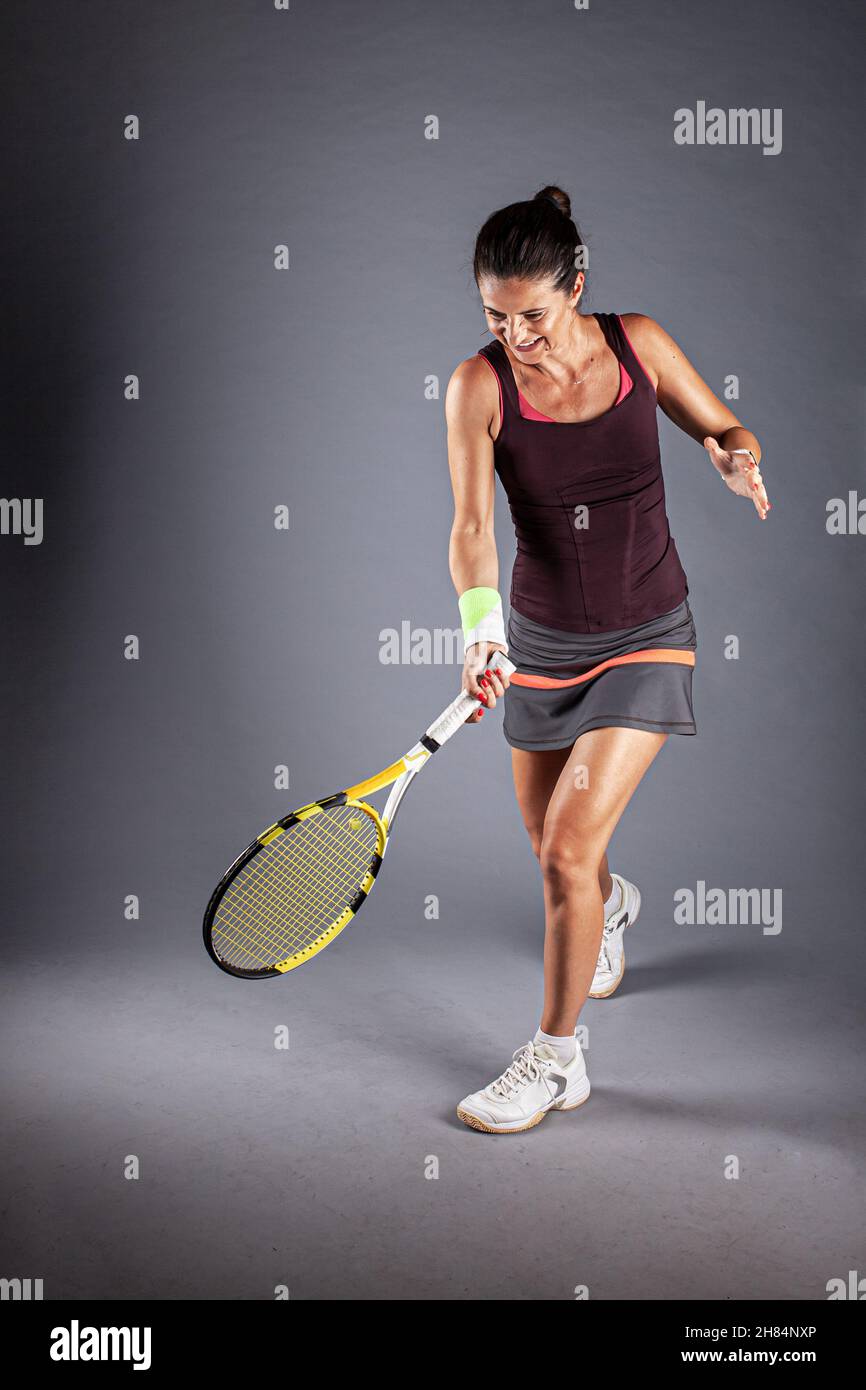 Professional female tennis player. Girl swinging racket Stock Photo - Alamy