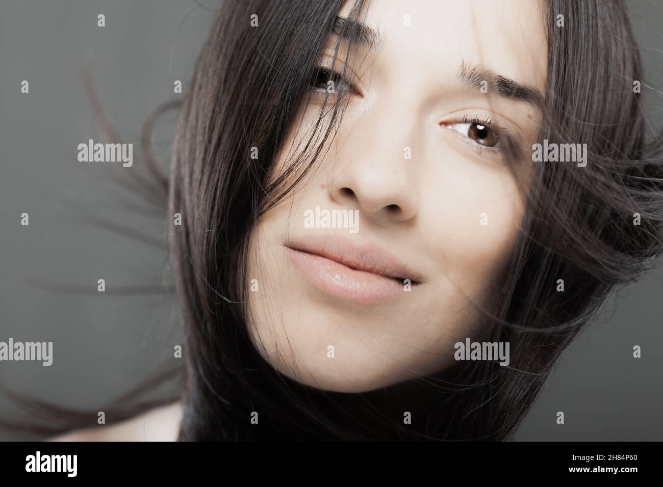 beauty fashion studio portrait of a beautiful young girl with windy ...