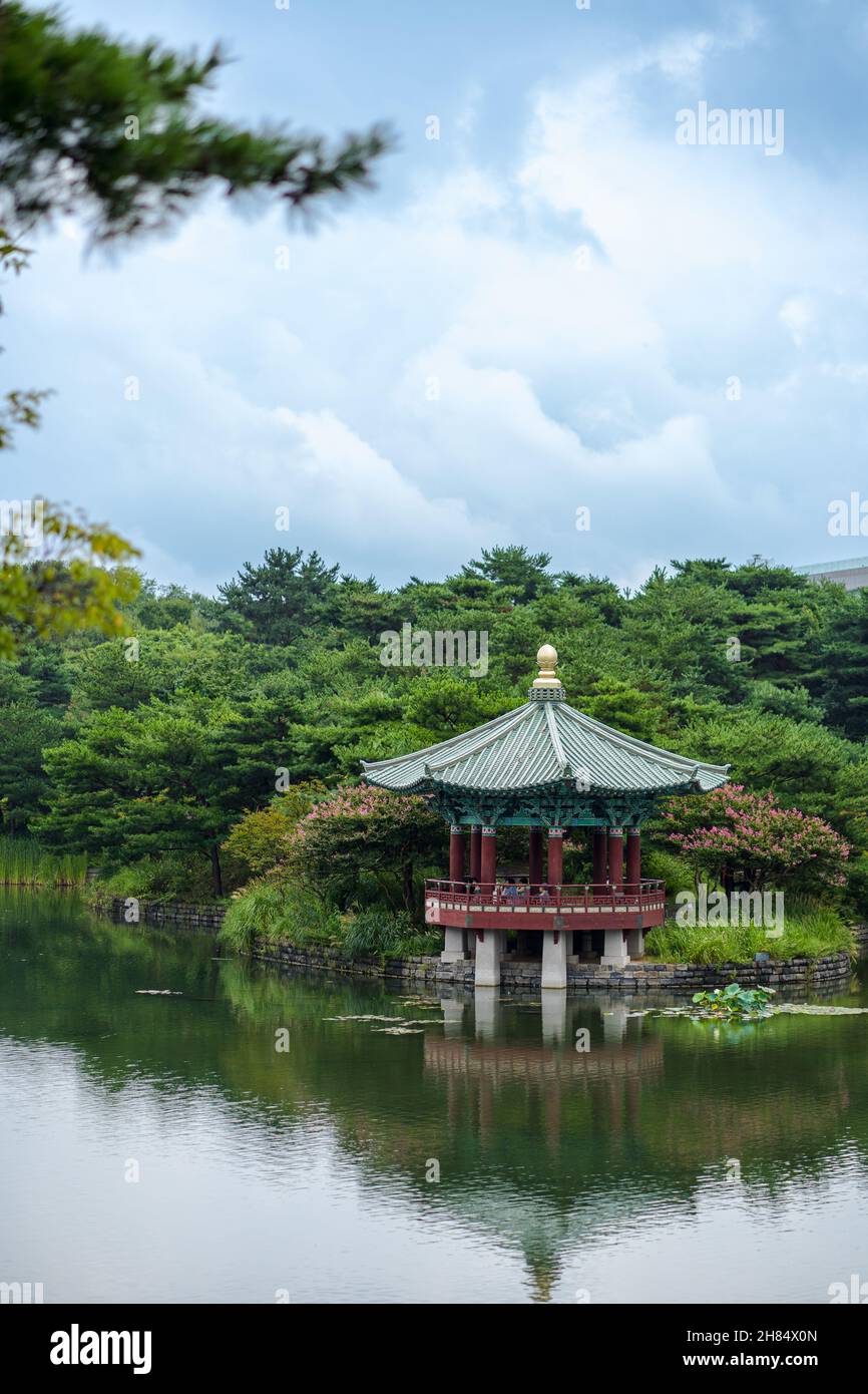 Vertical shot of a traditional building reflecting in a pond in South ...