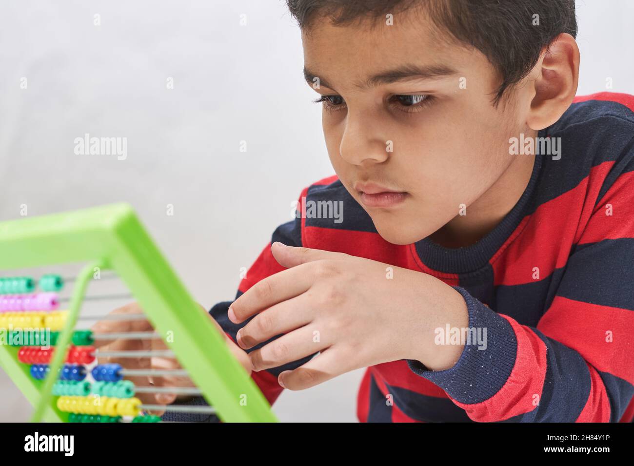 Schoolboy do mental math. Mental mathematics. 8 years old multiracial ...