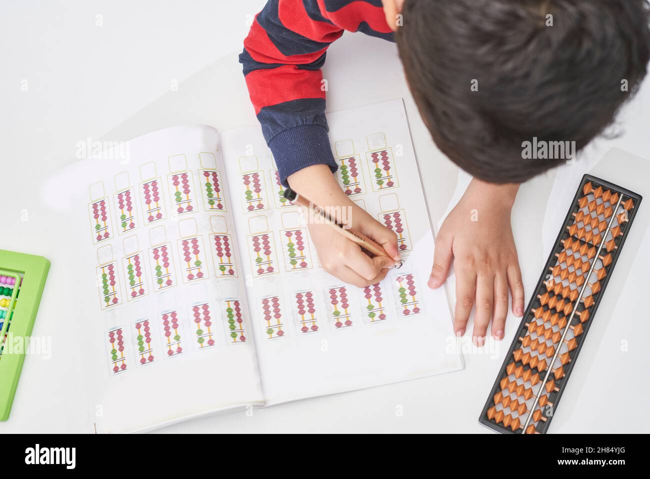 Schoolboy do mental math. Mental mathematics. 8 years old multiracial ...