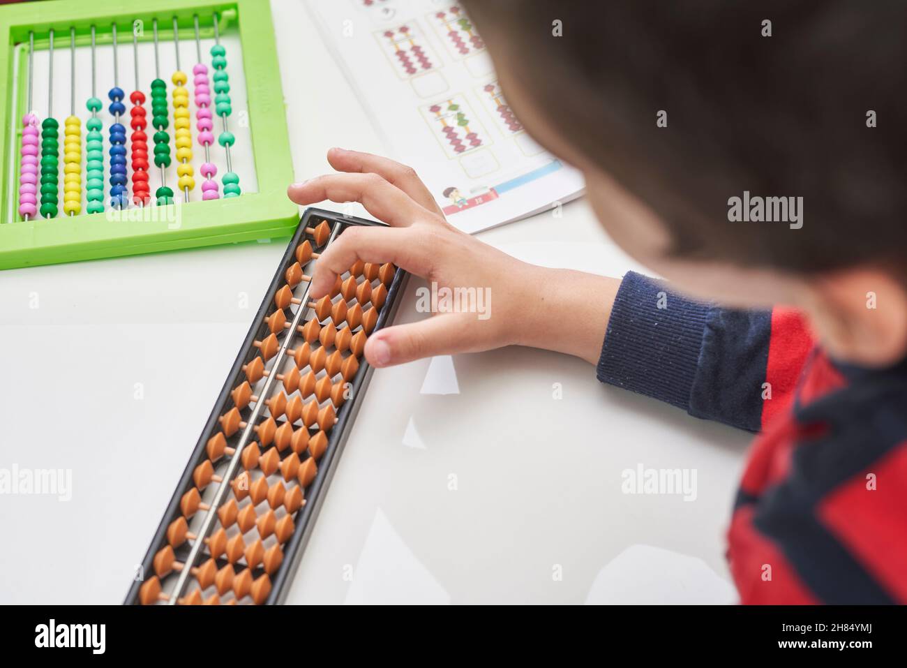 Schoolboy do mental math. Mental mathematics. 8 years old multiracial ...