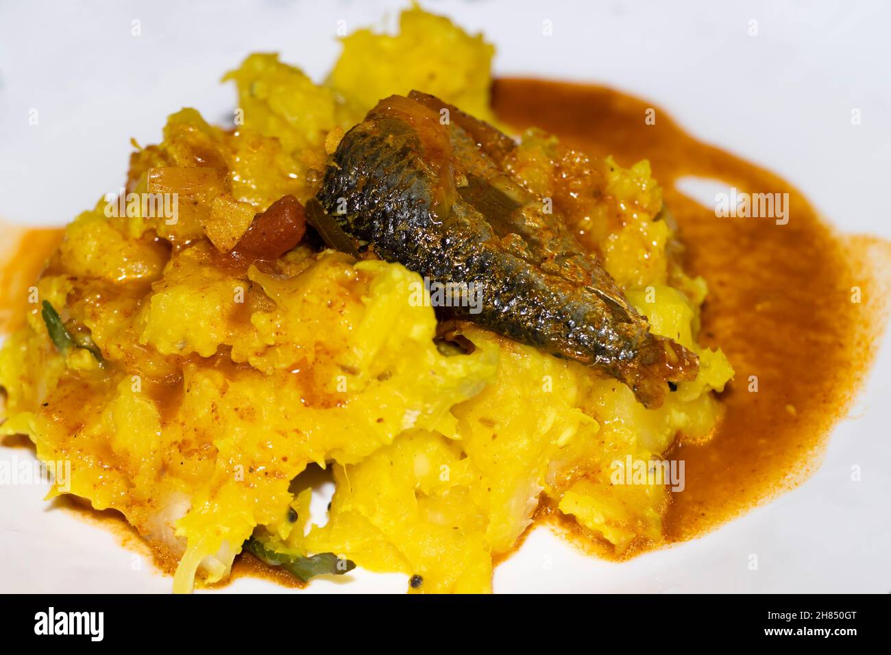 Closeup Image Of Kerala Style Yellow Tapioca With Fish Curry In White ...