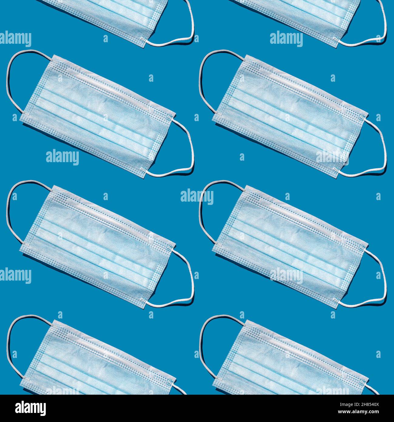 Seamless pattern of disposable face masks. Blue masks on a blue ...