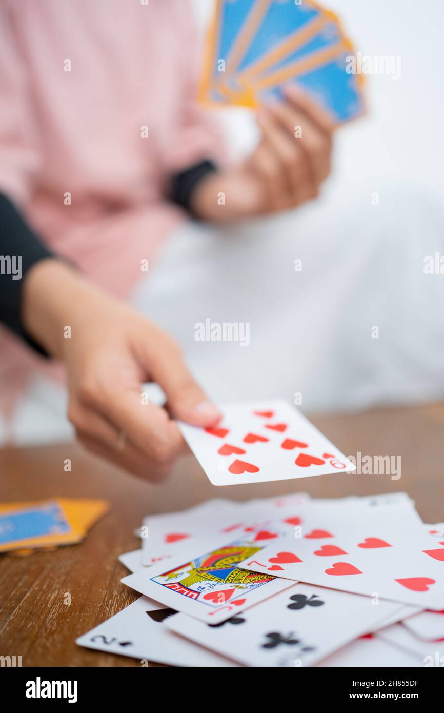 Close up of female hands putting cards while playing cards Stock Photo ...