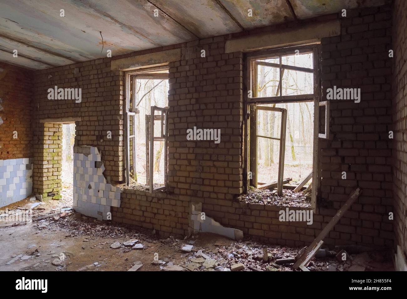 Abandoned Soviet building with tiled walls and large bright windows ...