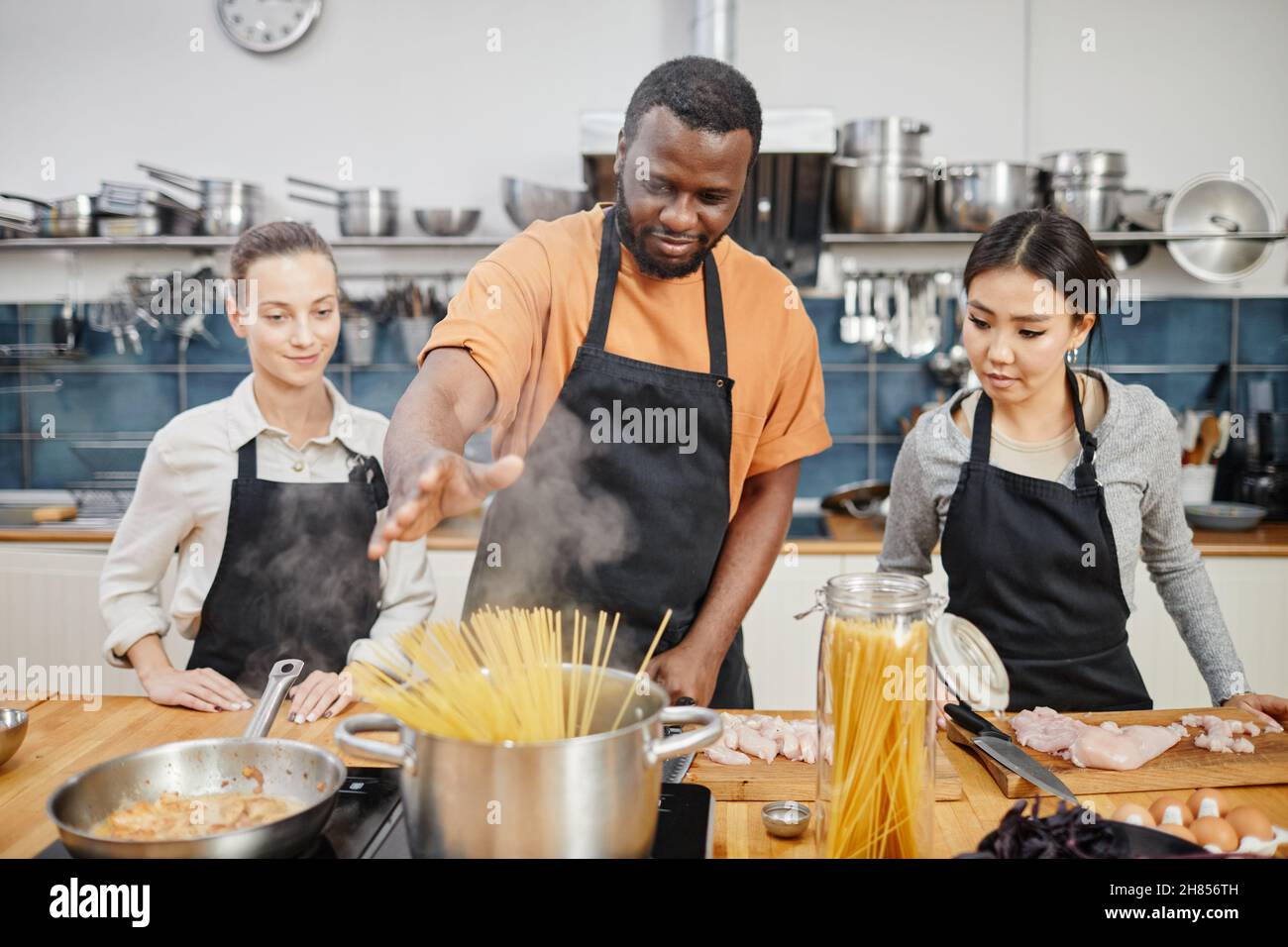 Portrait of African-American man making pasta during cooking class in ...