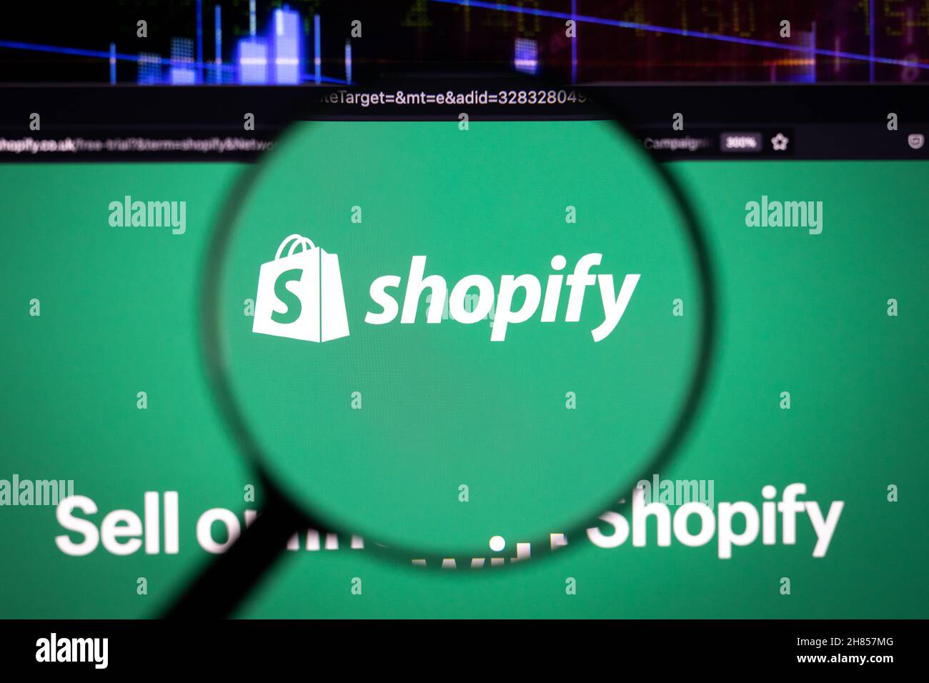 Shopify company logo on a website, seen on a computer screen through a ...