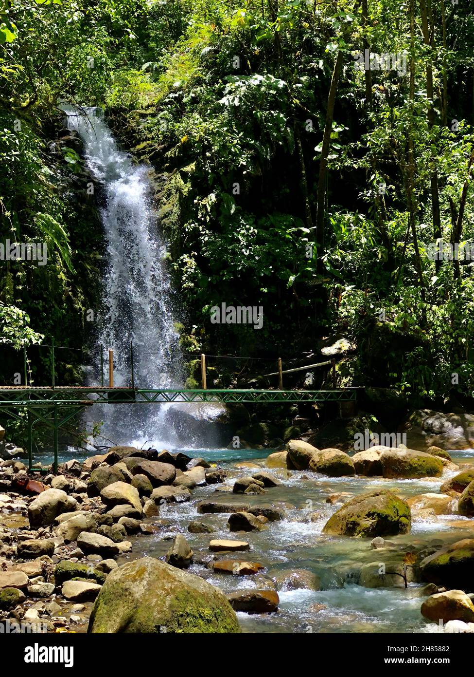 Mesmerizing view of a bridge over the river water with waterfall ...