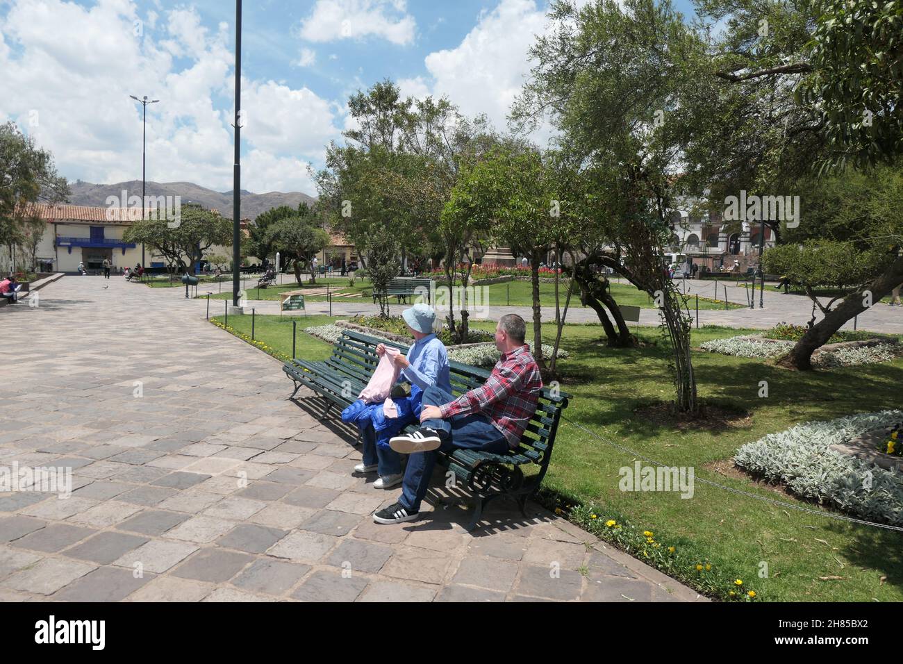 people sitting on bench in Cusco Peru South America Andes mountains ...
