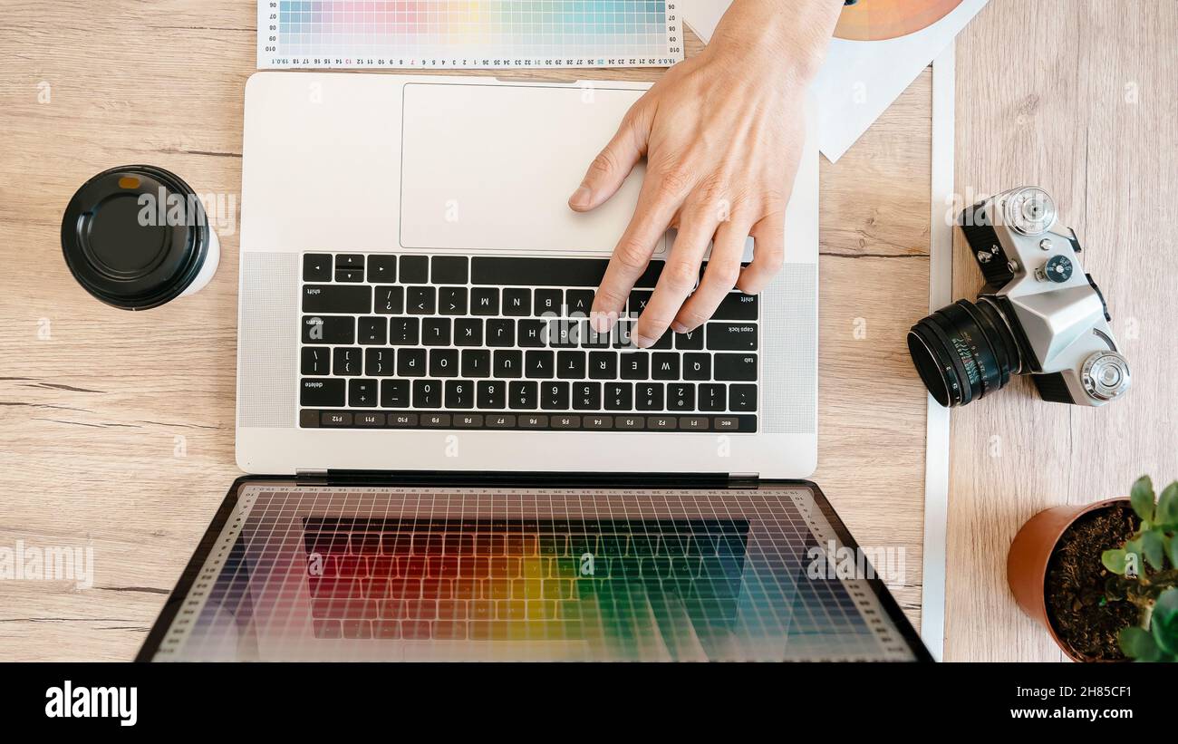 top view. designer using a laptop to work with the color palette ...