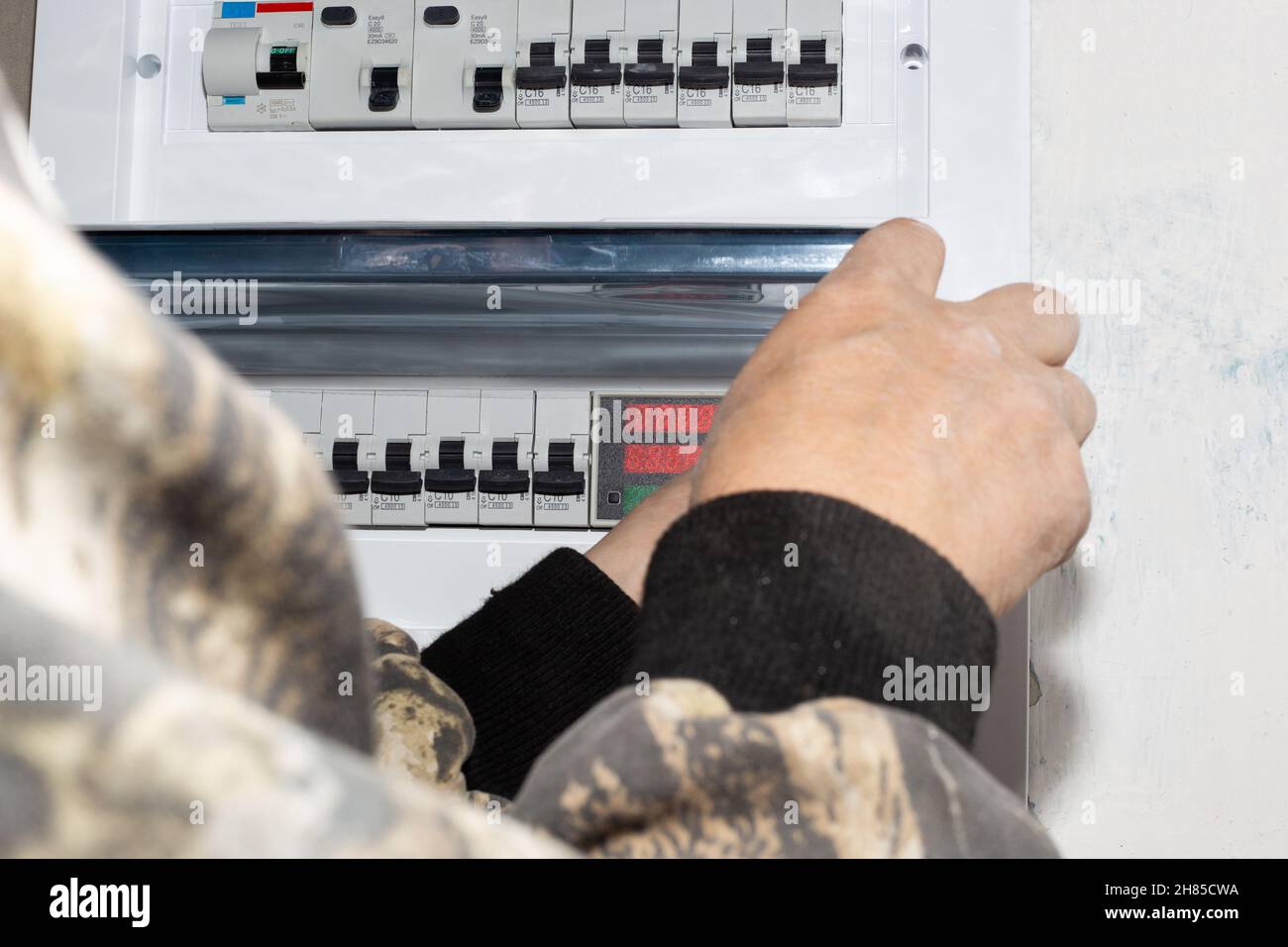 Electrical switchboard. A electrician installs a multifunctional shield ...