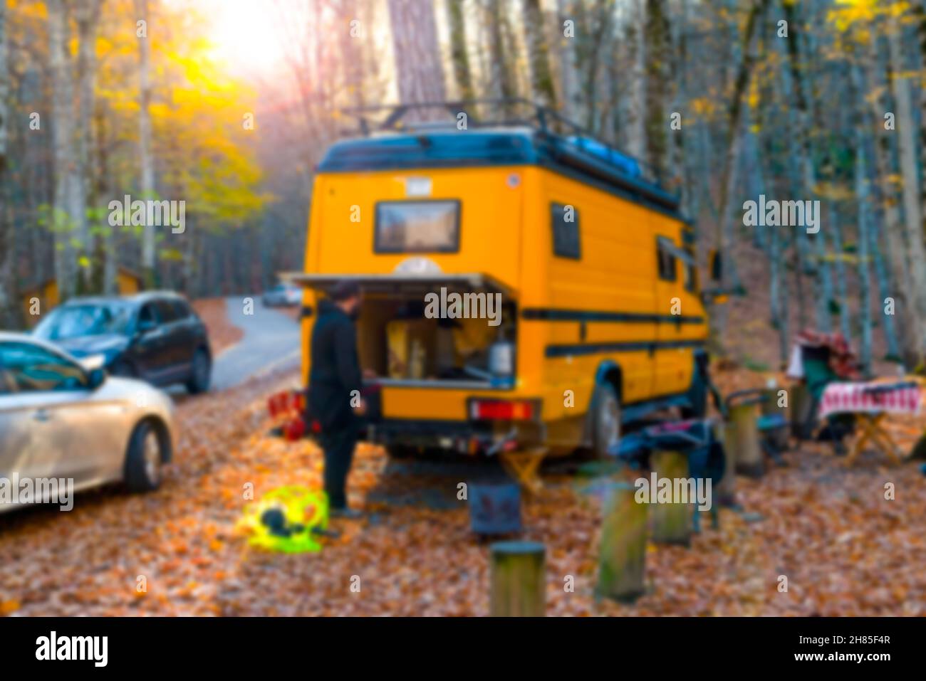 Unfocused blurred back view camper with orange color caravan in a ...