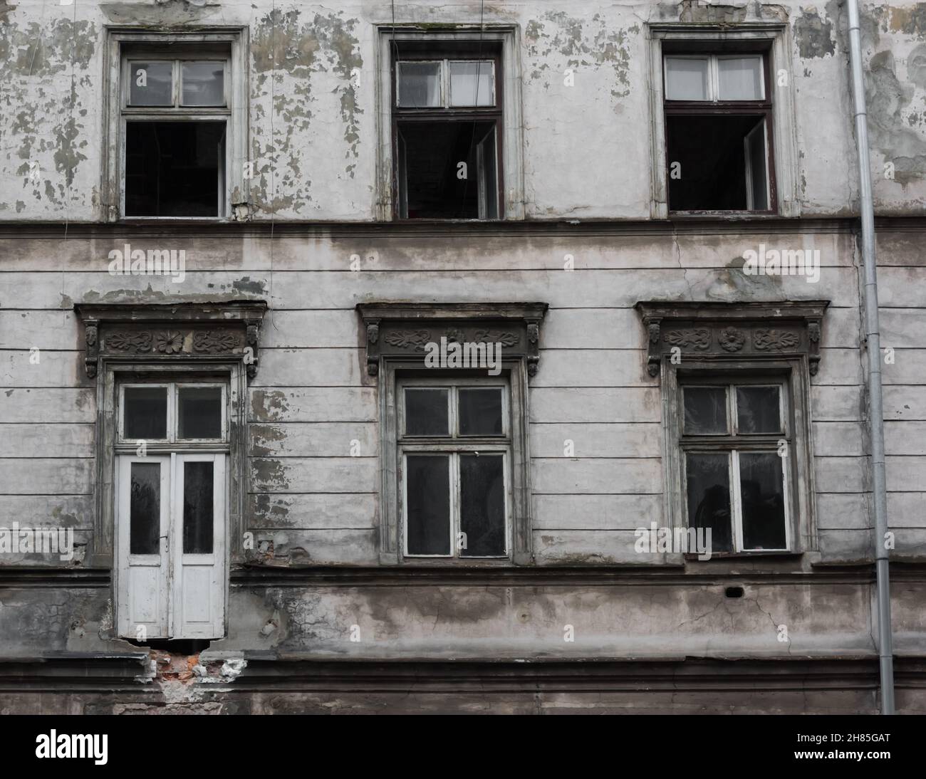 Five windows and an old door of a house Stock Photo - Alamy