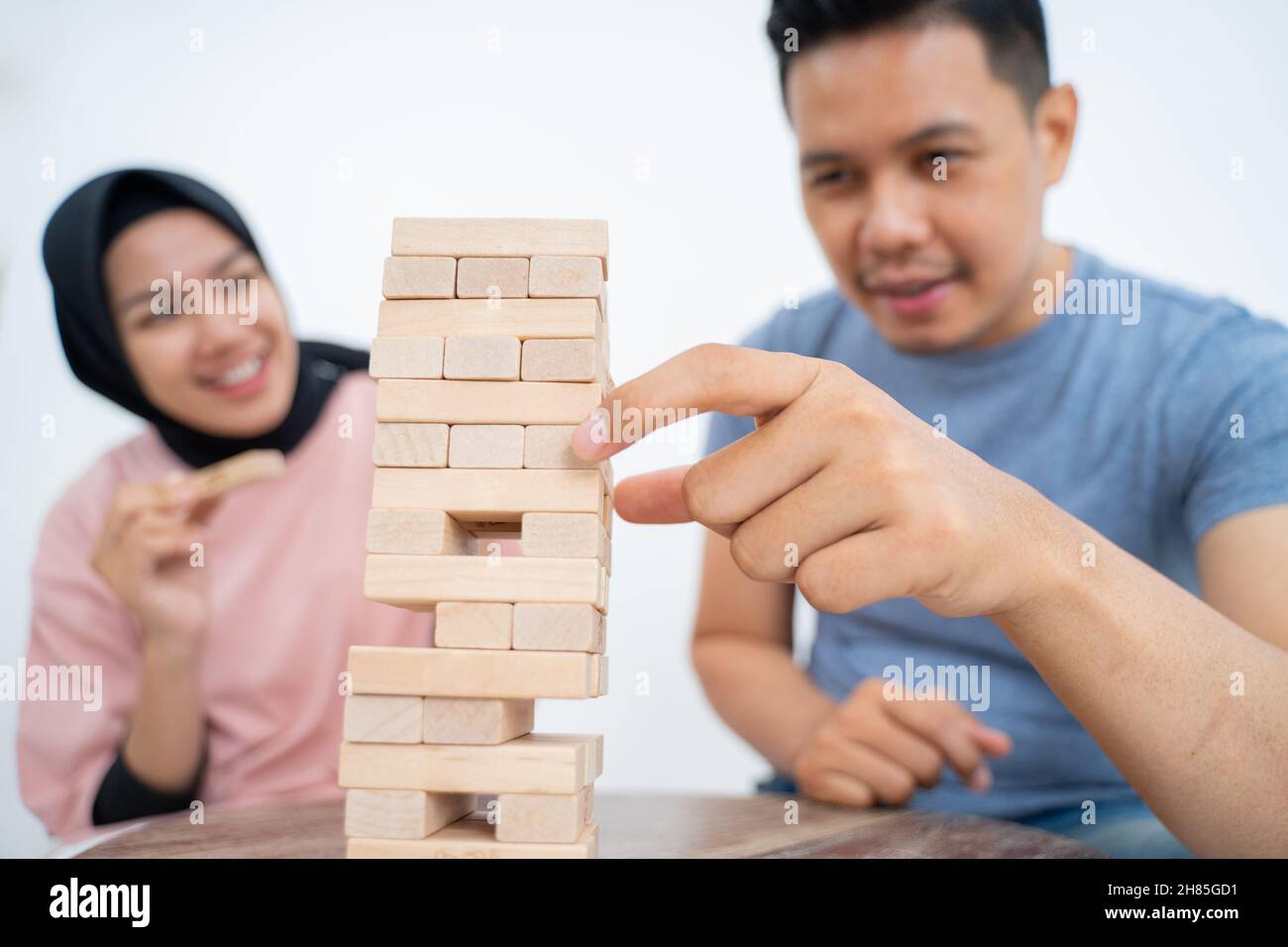 male hand trying to pick up block Stock Photo - Alamy