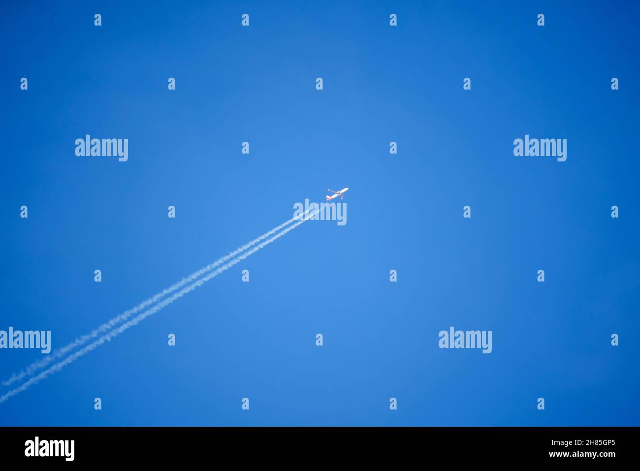 An Easyjet Airbus A320 twin engine jet airliner in deep blue sky with ...