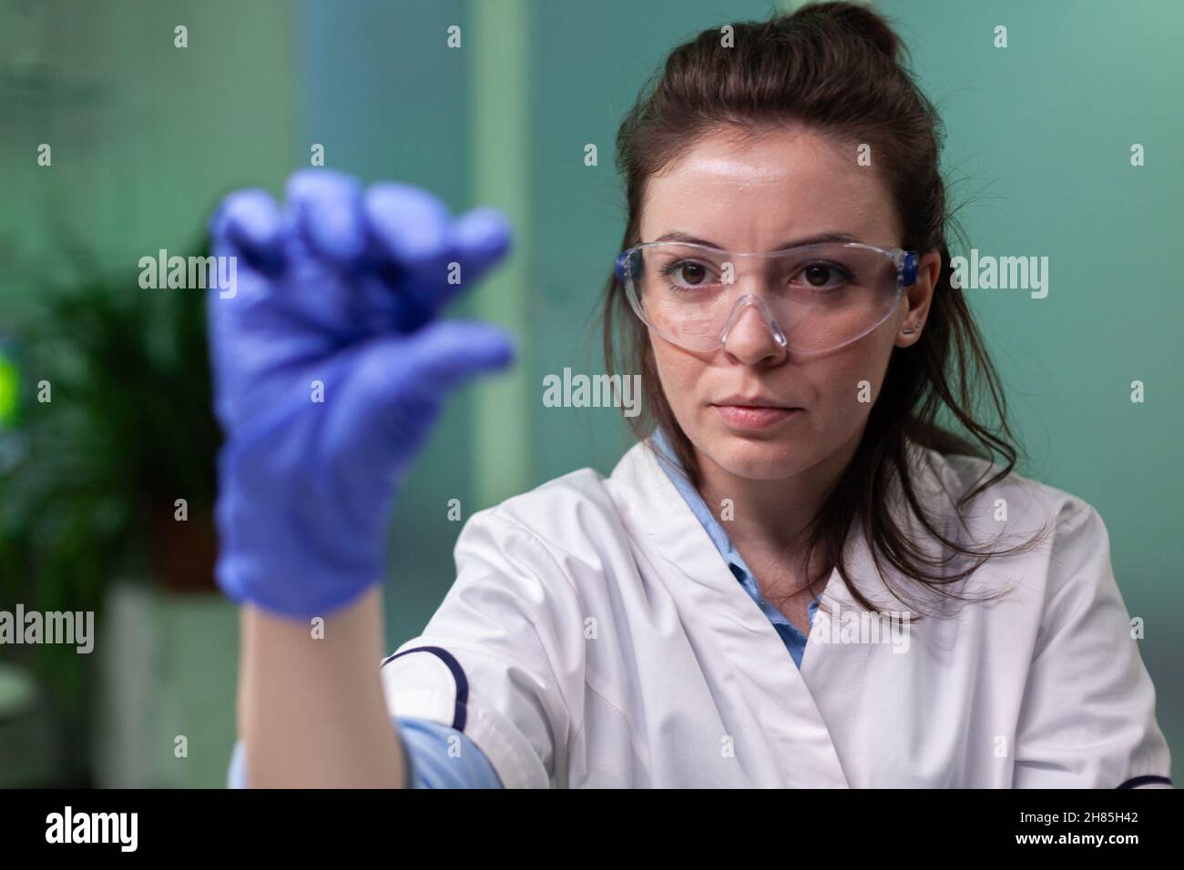 Portrait of chemist scientist woman analyzing microscope slide with ...