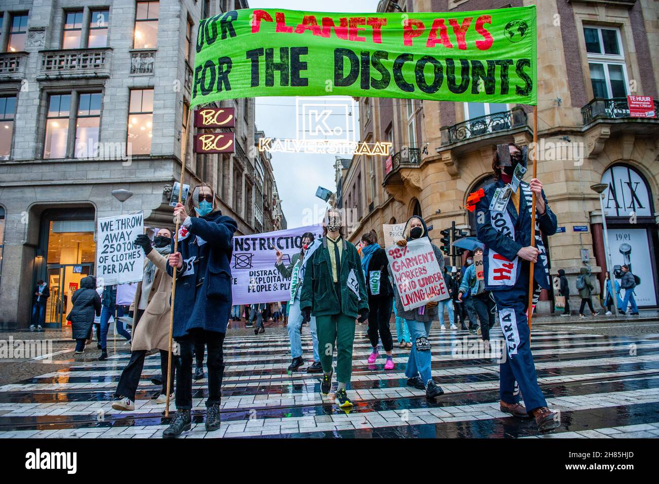 XR activists hold a banner against consumerism during the demonstration ...