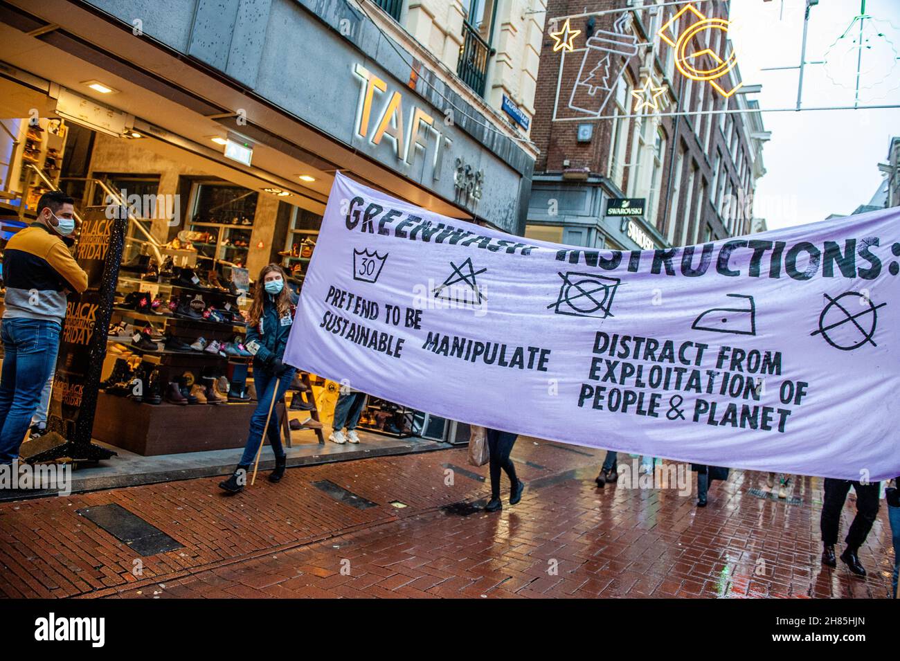 XR activists hold a banner against consumerism during the demonstration ...