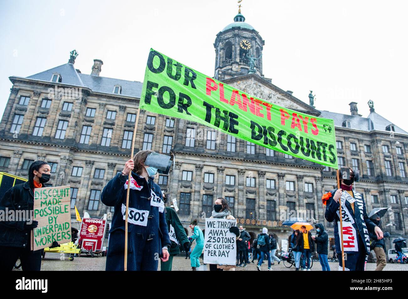 XR activists hold a banner against consumerism during the demonstration ...