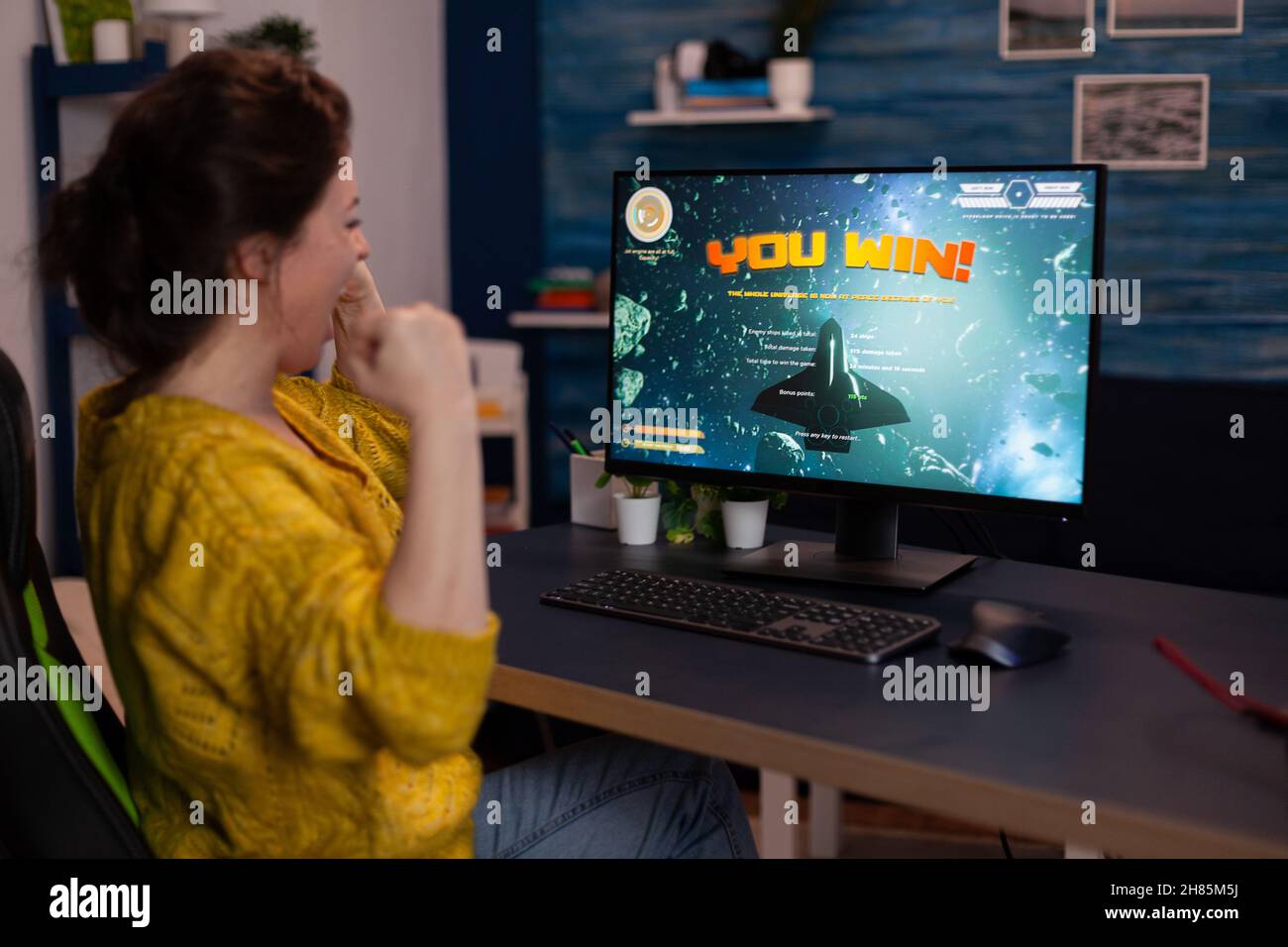 Excited competitive winner player woman winning space shooter ...