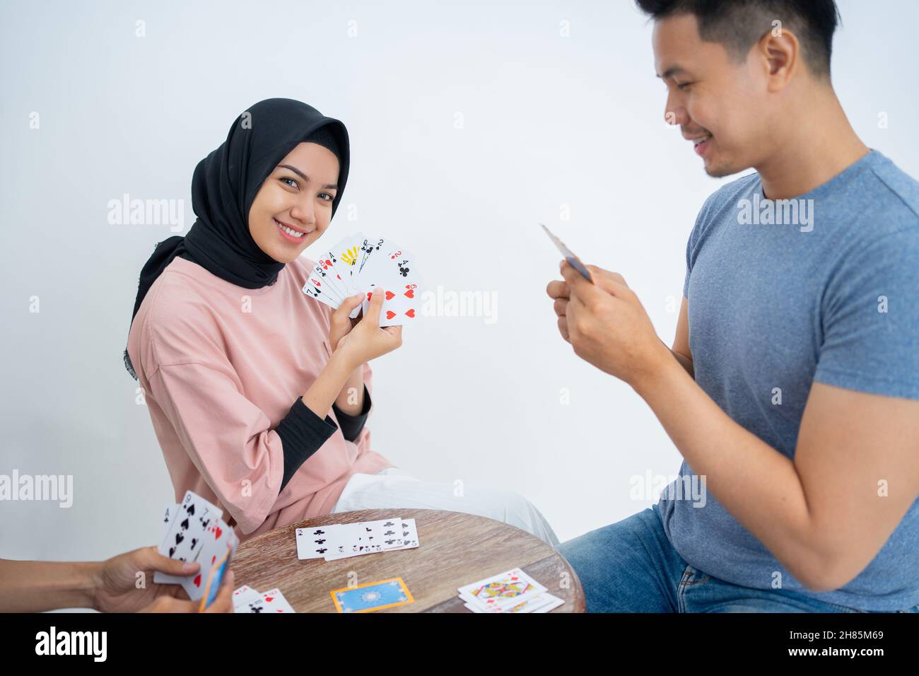 Woman showing cards being held while playing cards Stock Photo - Alamy