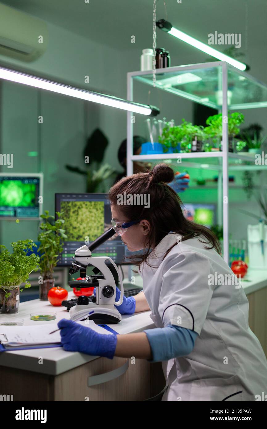 Biologist researcher doctor analyzing gmo plants sample using medical ...