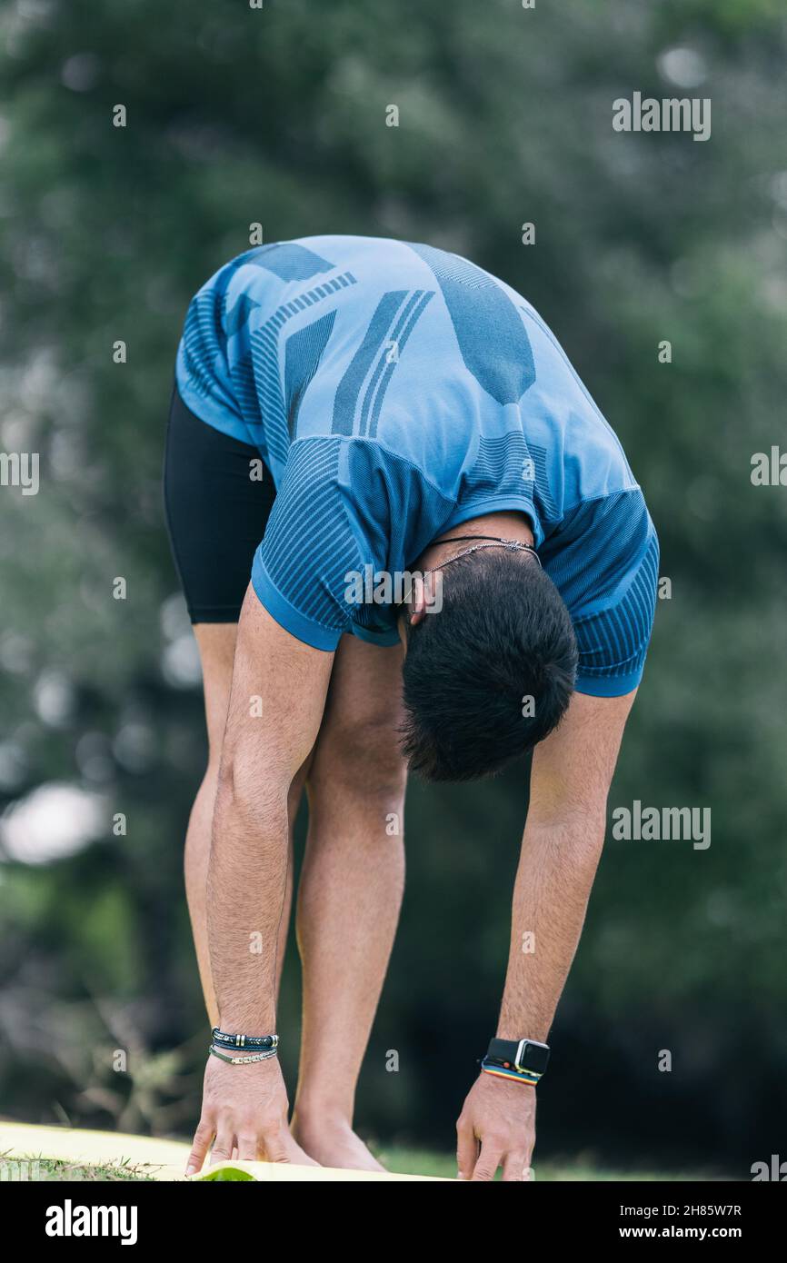 Adult man stretching her back while doing yoga outdoors Stock Photo - Alamy