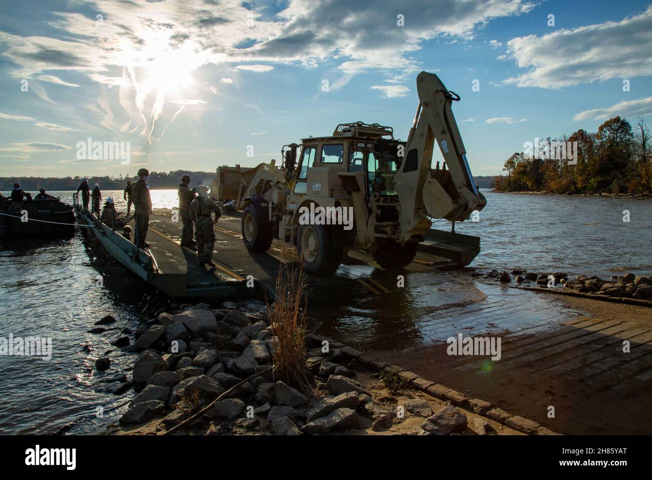 U.S. Army Soldiers with the 299th Multi-Role Bridge Company load a high ...