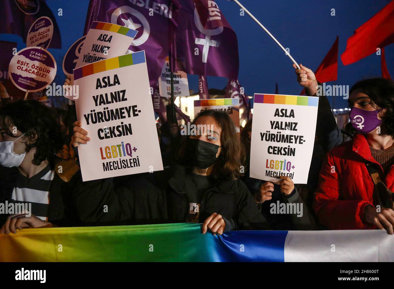Demonstrators hold placards saying "You will never walk alone" during ...