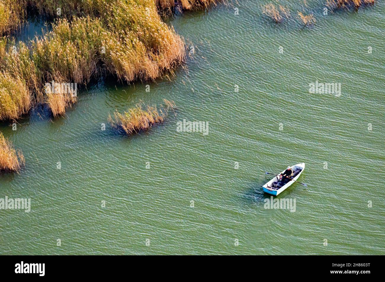 An aerial view of a fishing boat on Lake Chany in Novosibirsk, Russia ...