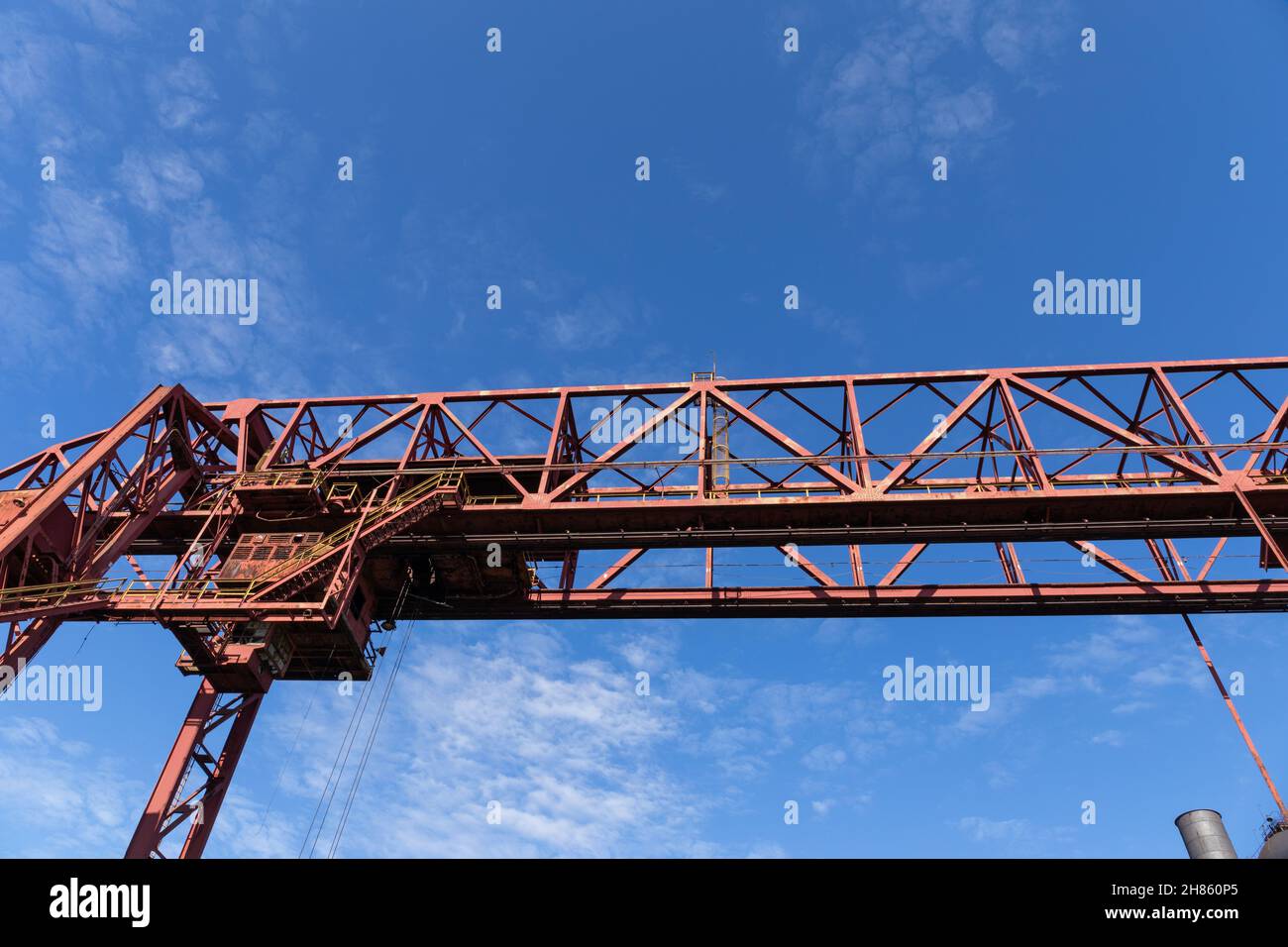 Overhead trusses, catwalks, and stairs of a massive industrial ...