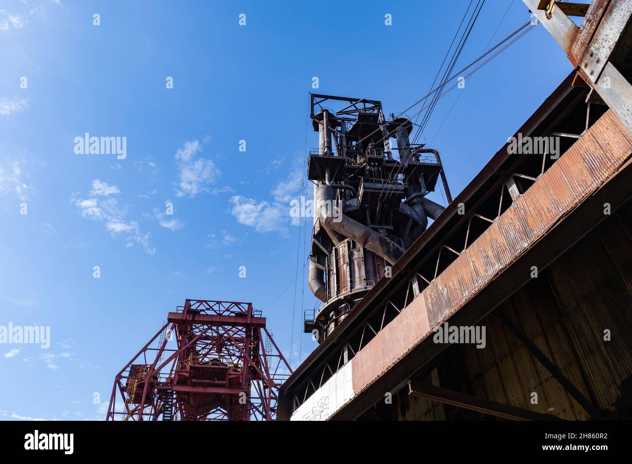 View looking up at large structures in an old steel mill plant ...