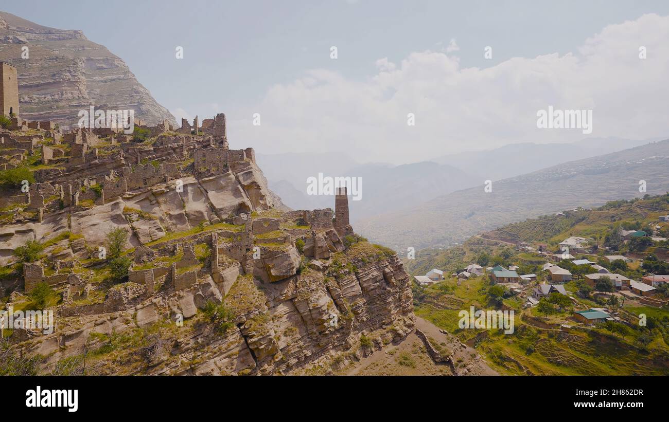 Ruins of ancient city on rocks on sunny day. Action. Stone city on rock ...