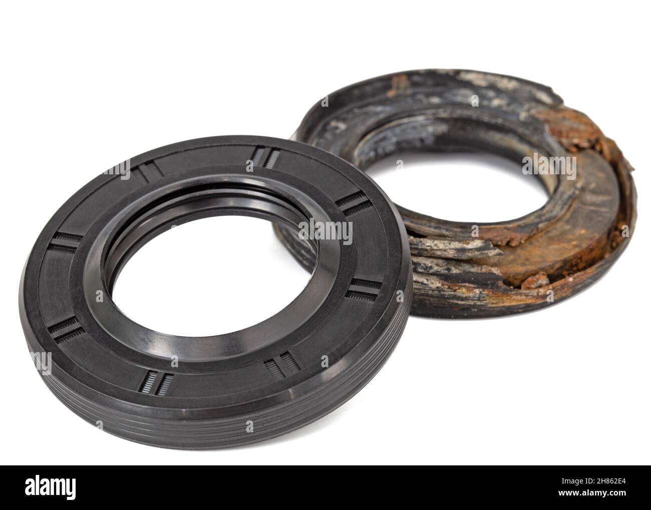 New and old oil seals for machine repair, isolated on white background ...